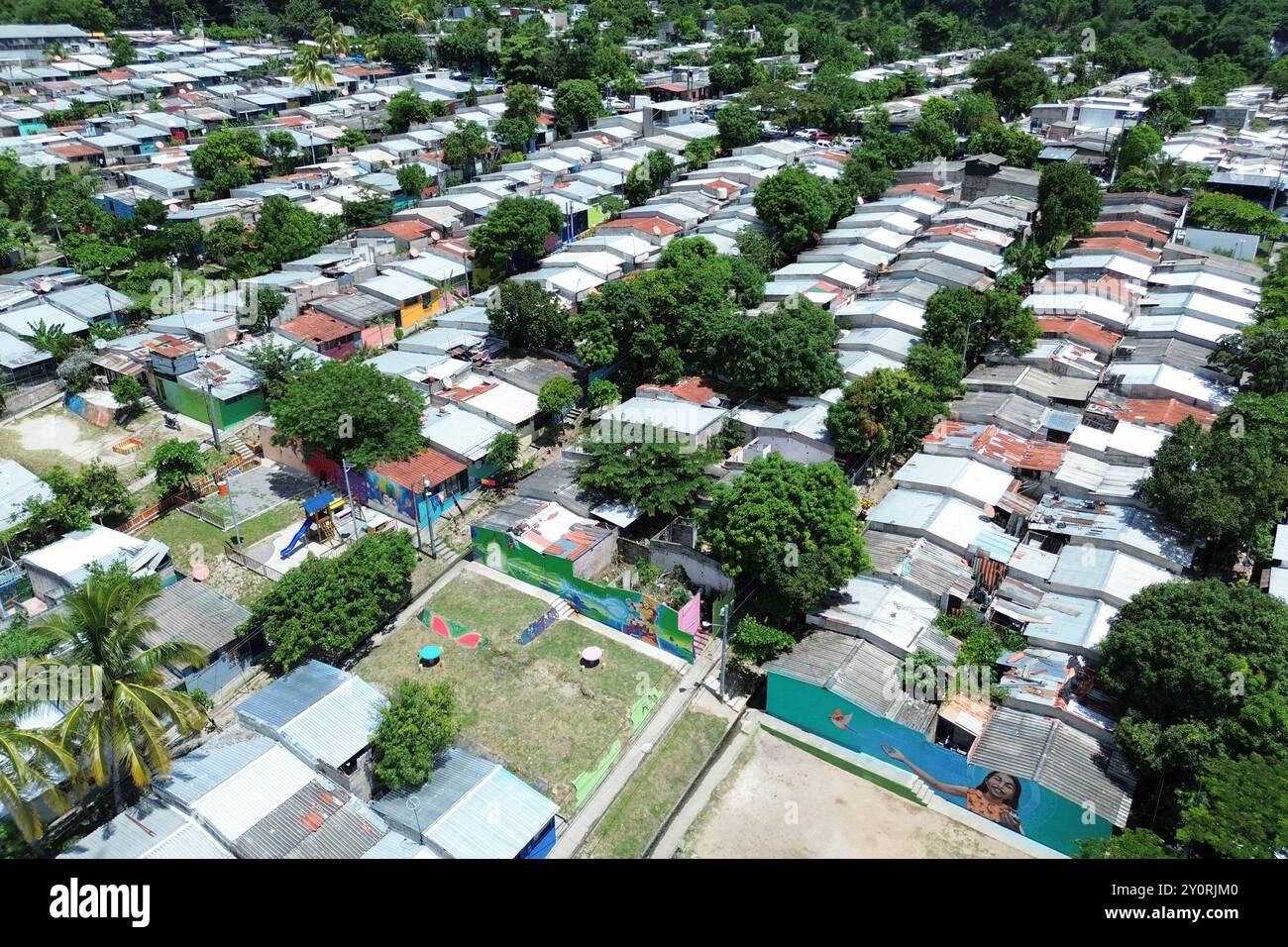 The sun shines on houses and their murals in the La Campanera ...