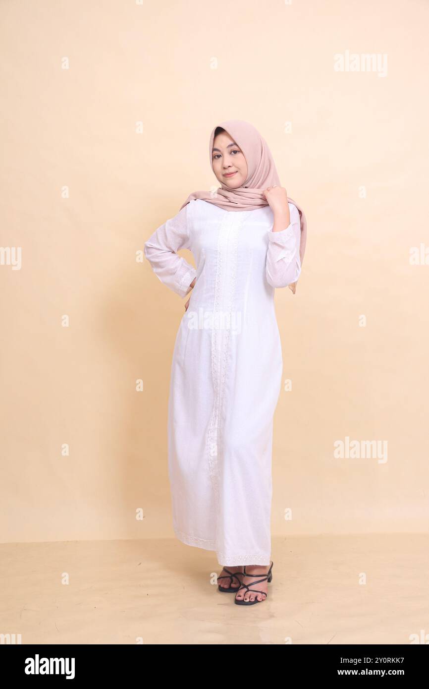 full body woman indonesia wearing beautiful dress smiling pose holding ...