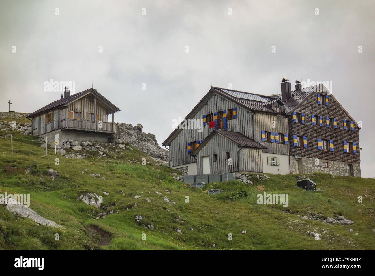 Wooden building of a mountain farm on a green hill, Alps, Austria ...