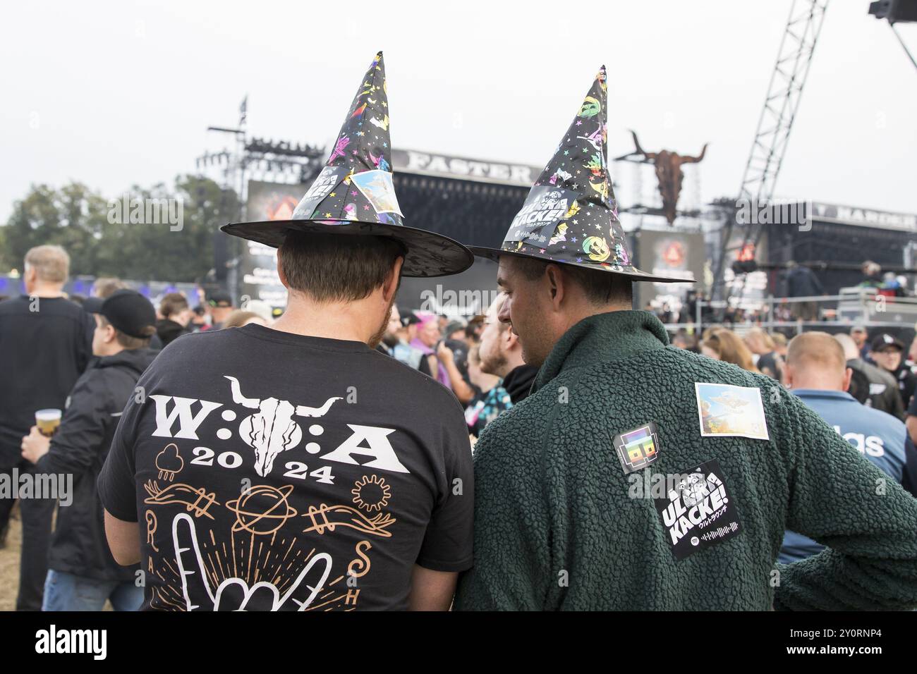 Two festival visitors with magic hats in front of the main stages at ...