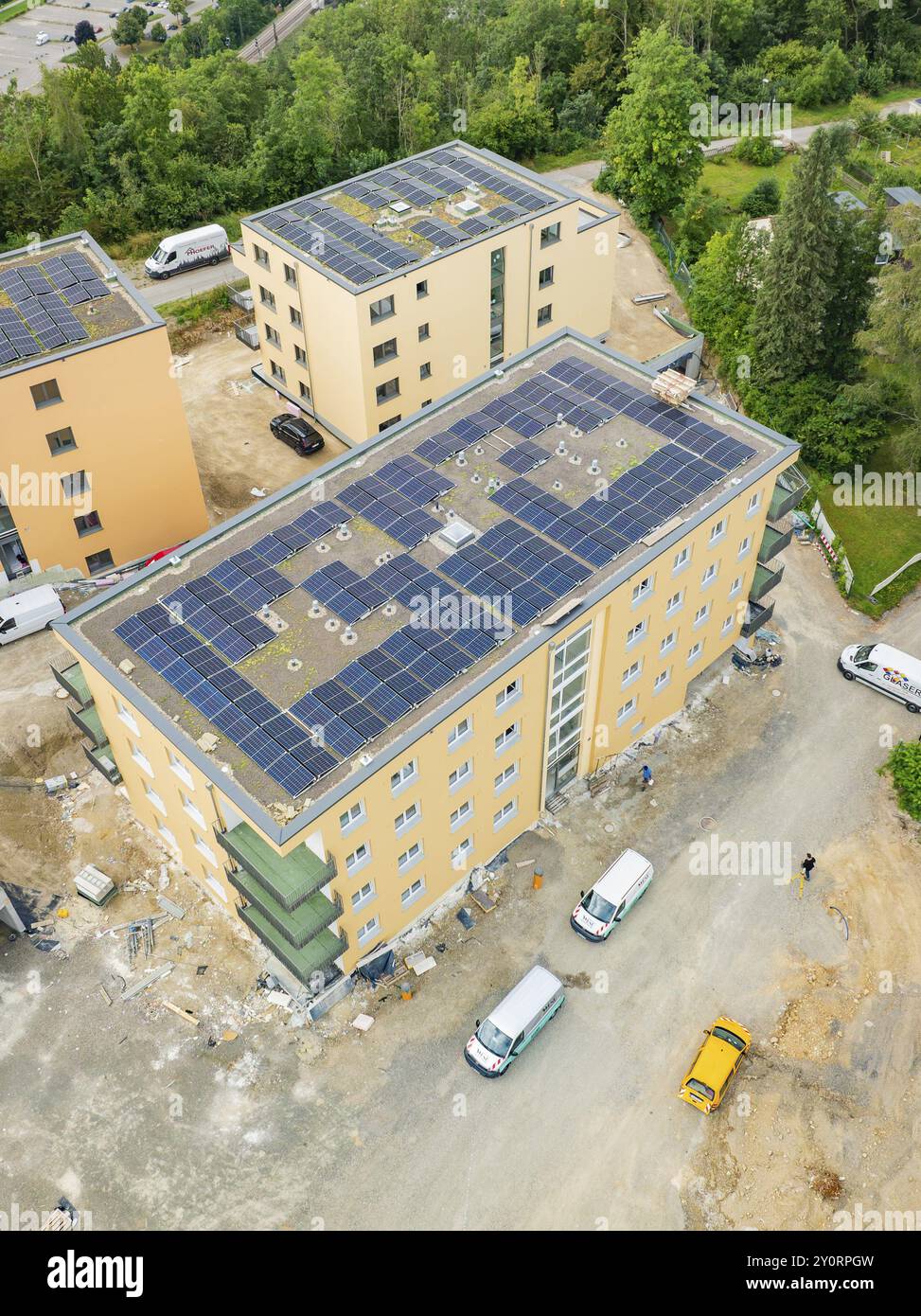 Aerial view shows buildings with solar panels on the roofs ...