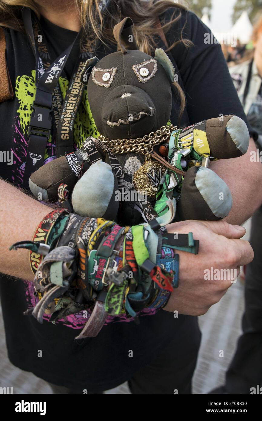 A photographer presents his mascot and his festival bands at the Wacken ...
