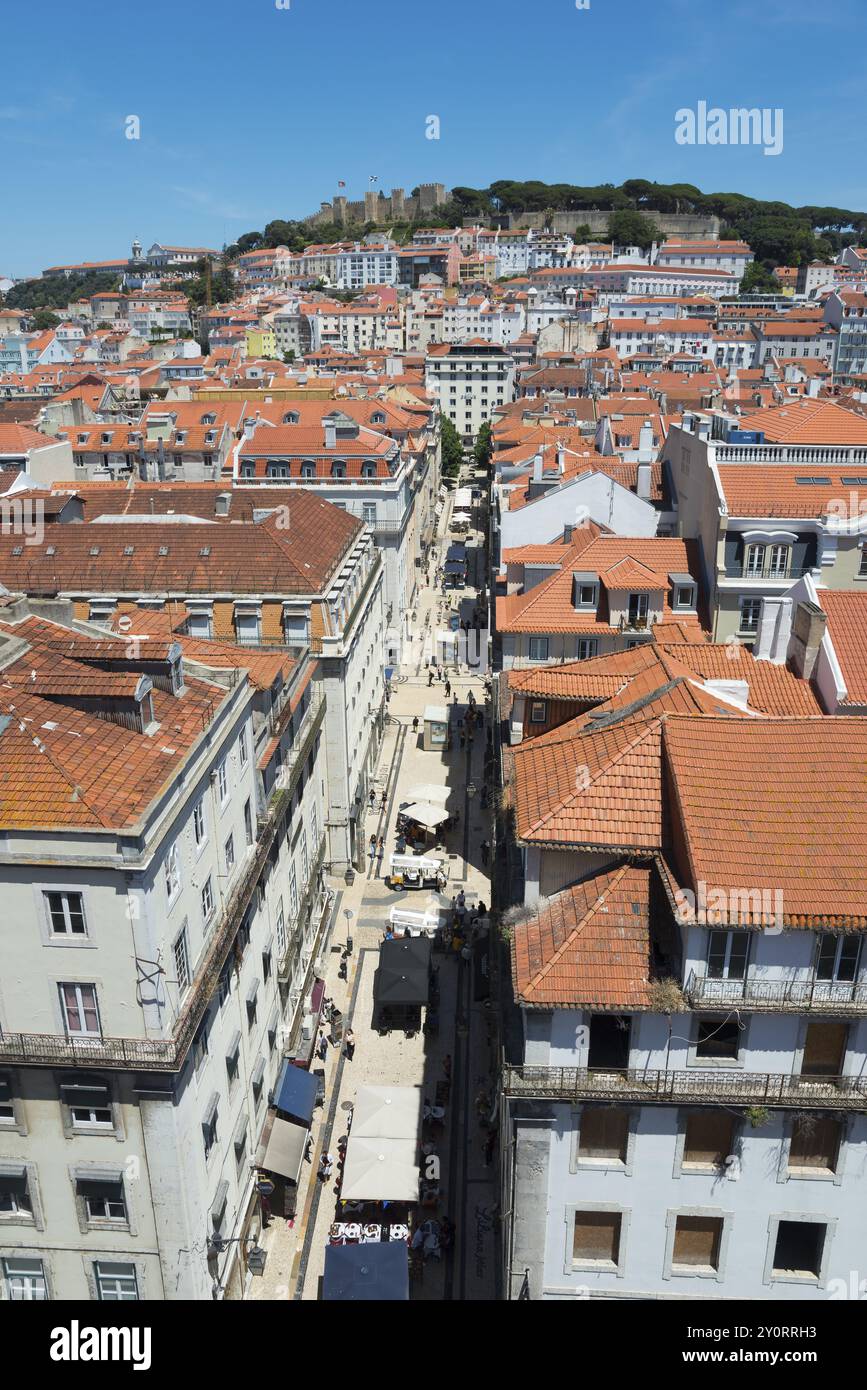 Aerial view of a narrow alley with tall buildings and red tiled roofs ...