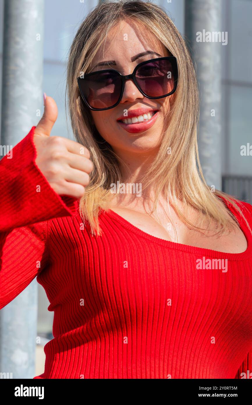 Vertical portrait Confident woman pointing up outdoors Stock Photo - Alamy