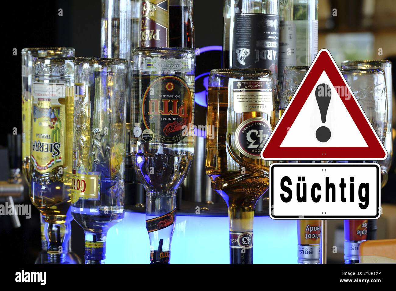 Alcohol bottles in a bar with a warning sign about the danger of ...
