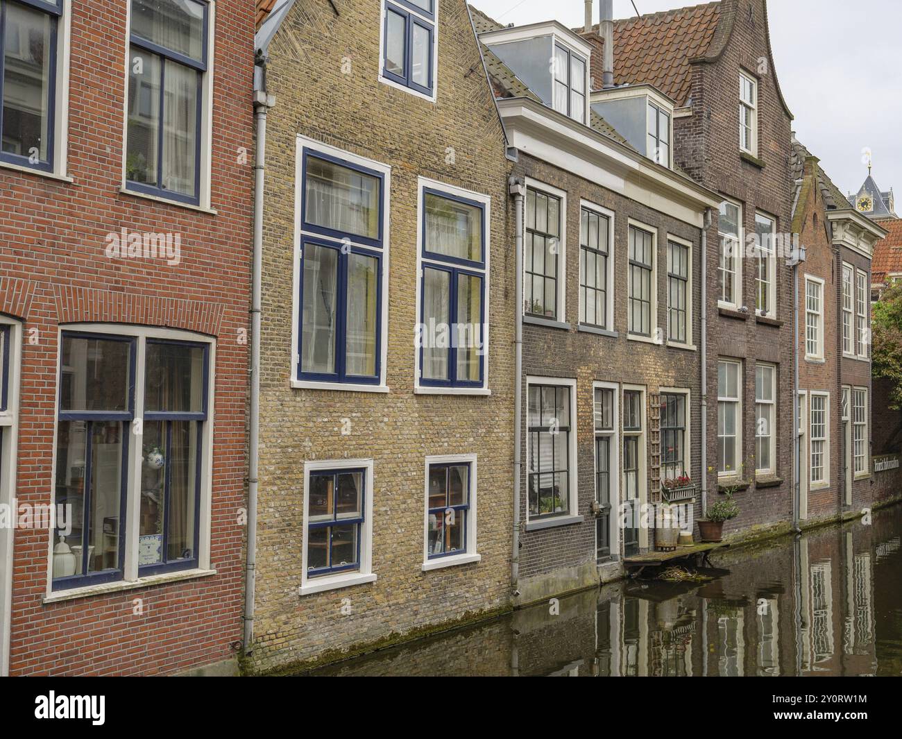 Historic houses with large windows along a canal, quiet urban environment, delft, netherlands ...