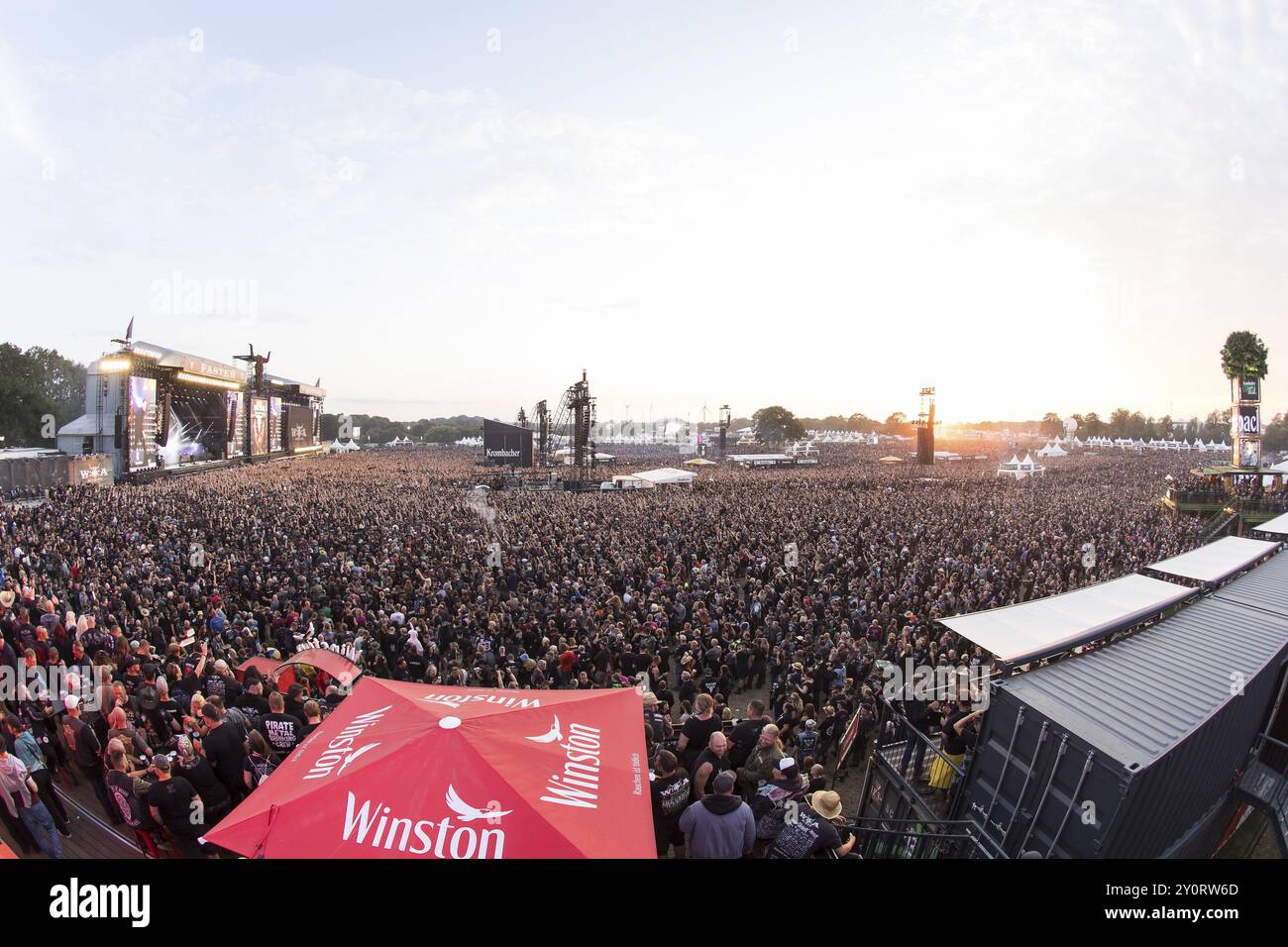Overview of the crowd with the setting sun and the two main stages ...