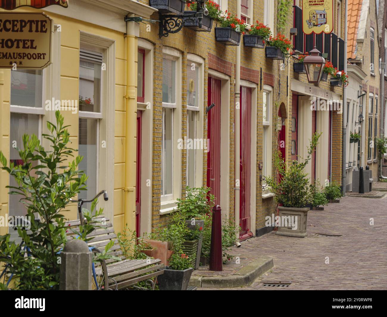 Picturesque street scene with colourful house fronts and flowers in ...