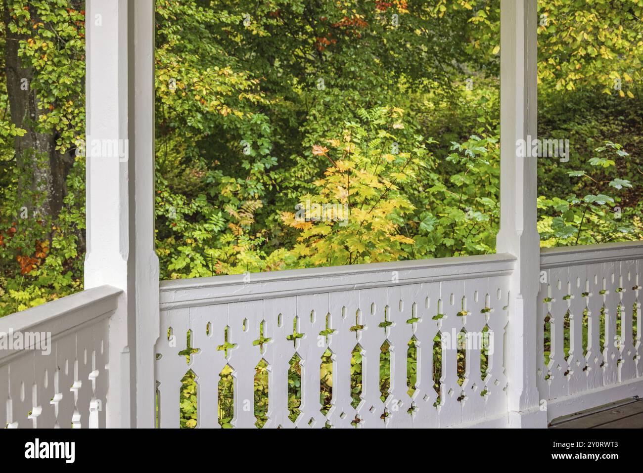 White wooden railing on a terrace with joinery and autumn colors in the ...