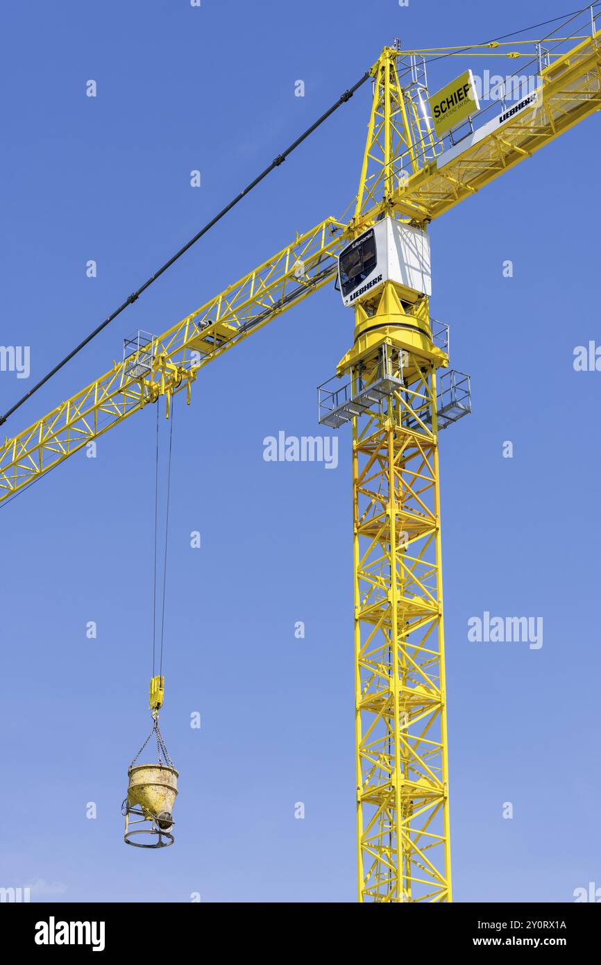 Construction crane with concrete bucket, concrete silo, crane bucket ...
