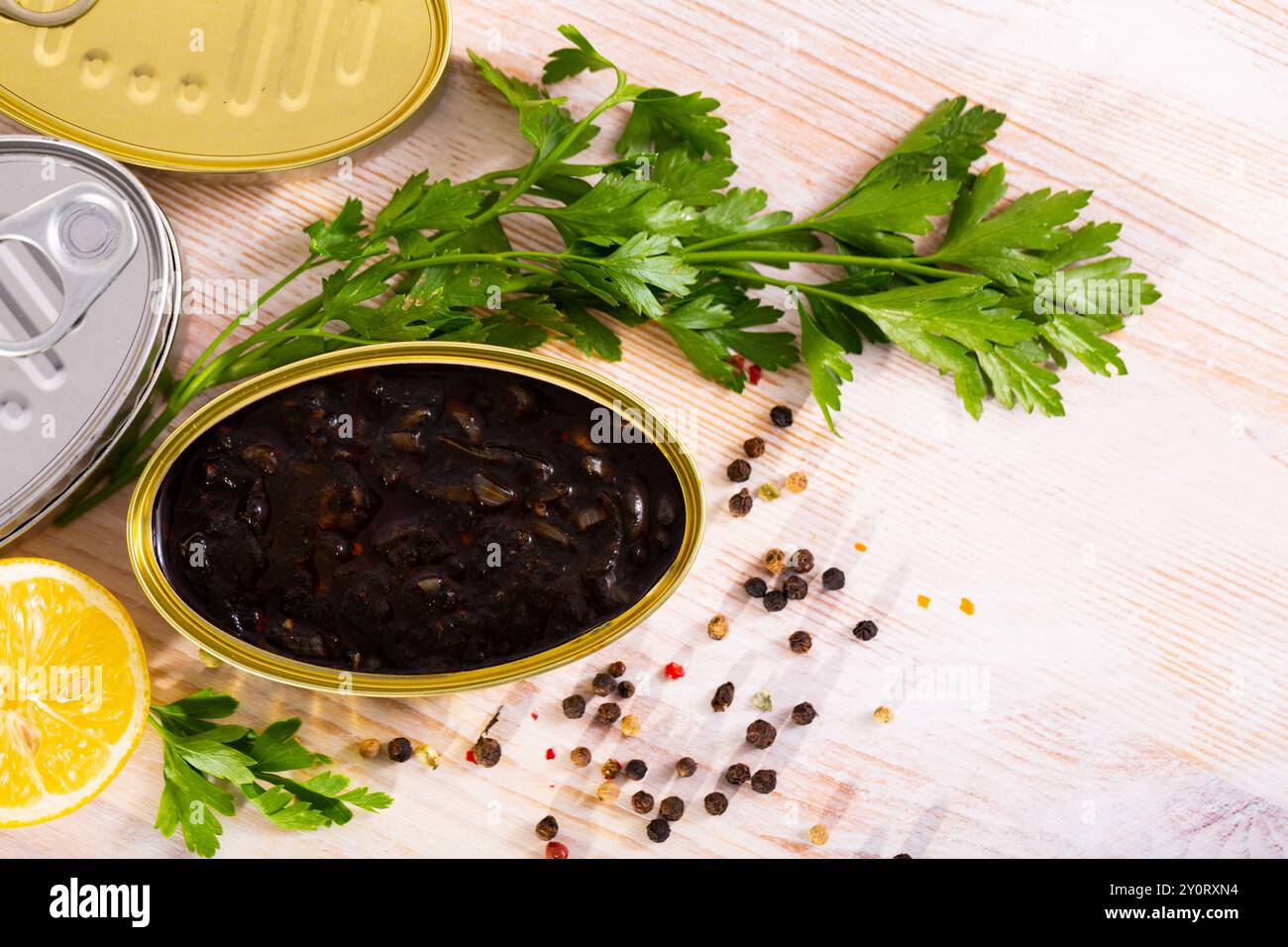 Canned seafood, chopped squid in ink Stock Photo - Alamy