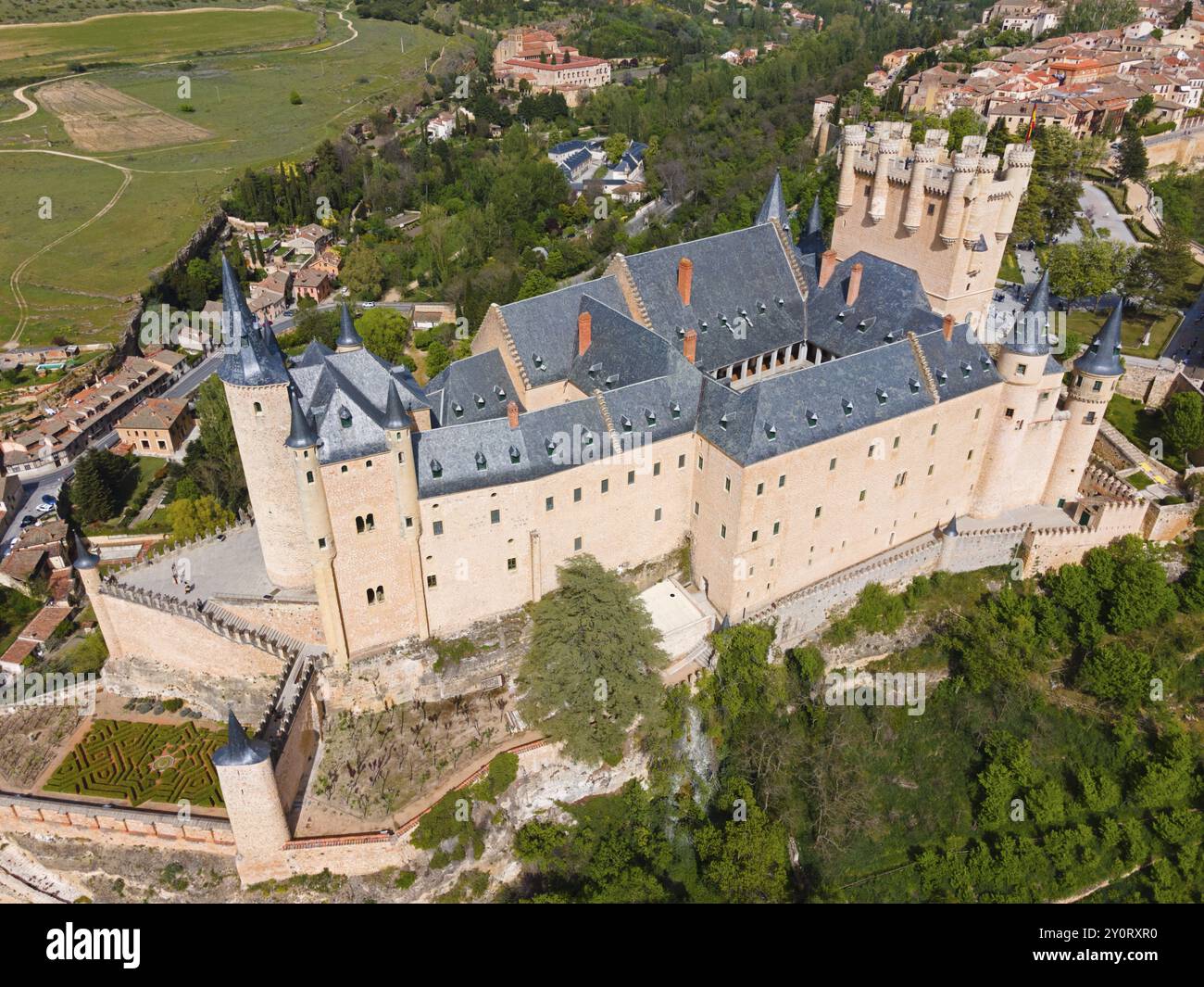 Medieval castle with striking towers, surrounded by landscape and green ...