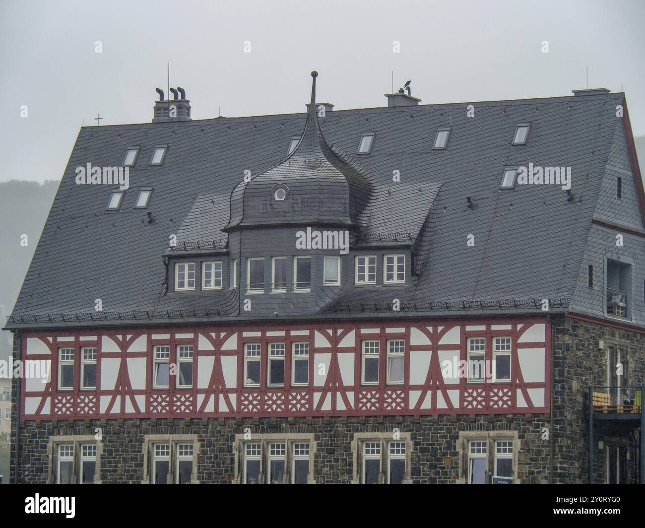 A large historic building with a striking slate roof and half-timbered ...
