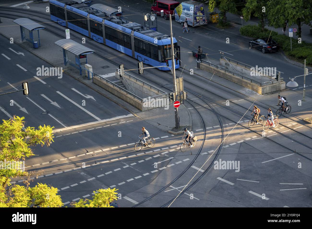 View from above of a road junction with tram and tram stop, cyclists ...