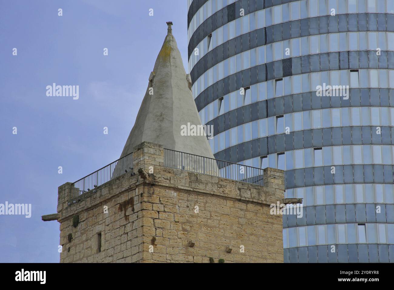 Spire of the historic Johannistor and glass window of the modern ...