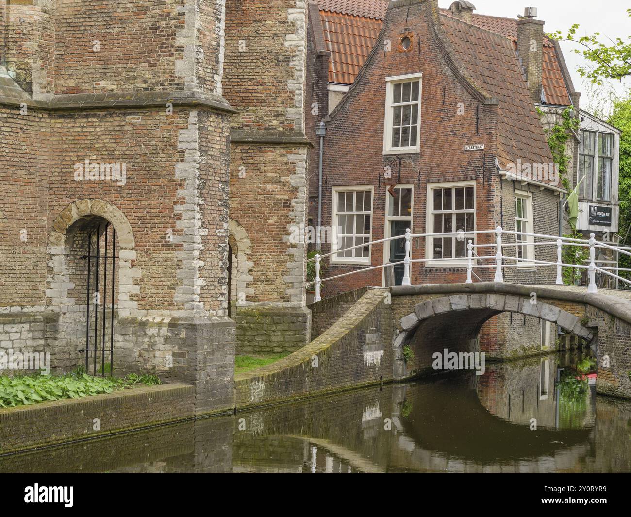 Historic brick building on a canal with small bridges and green ...