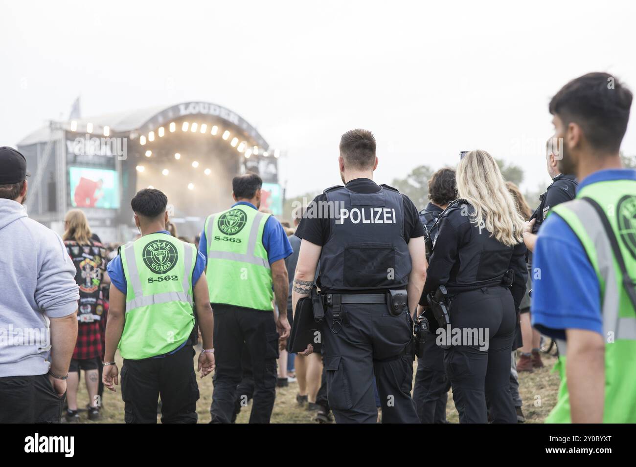 Police officers and metal guards in front of the Louder stage at the ...