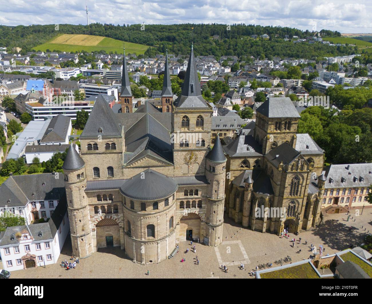 Historic cathedral with towers, surrounded by cityscape and hills under ...