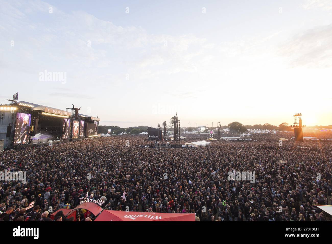 Overview of the crowd with the setting sun and the two main stages ...