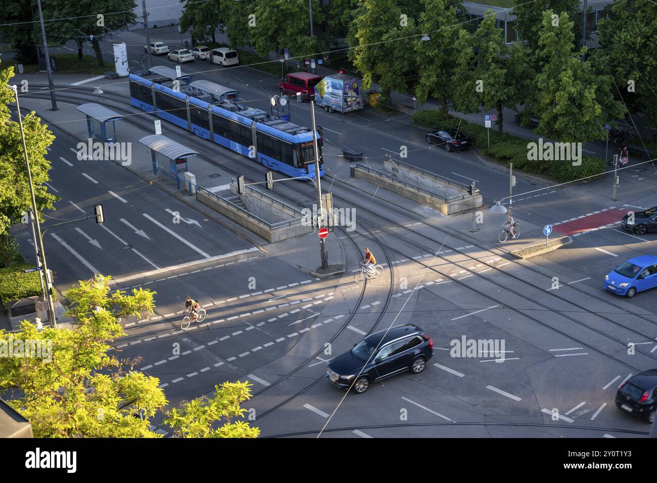 View from above of a road junction with tram and tram stop, cyclists ...