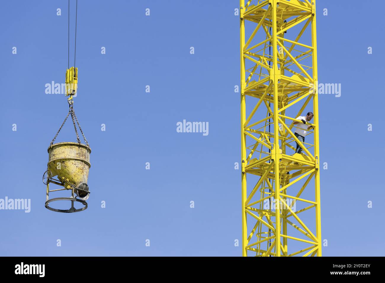Construction crane with concrete bucket, concrete silo, crane bucket ...