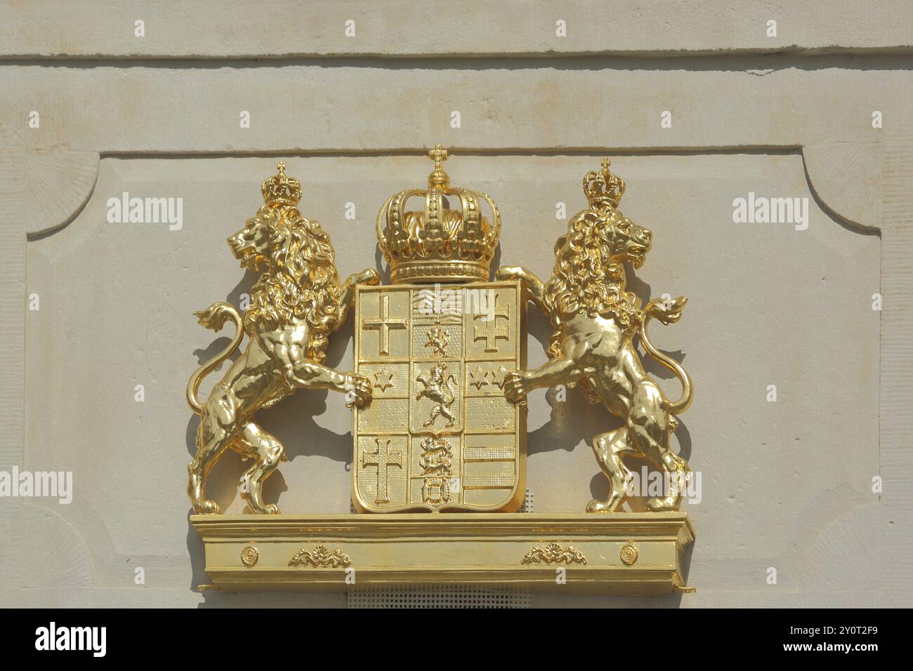 Two golden lion figures with coat of arms and crown, shiny, symmetrical ...