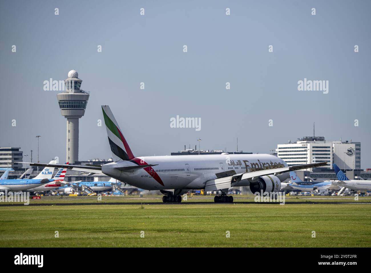 Emirates Boeing 777-31H, aircraft landing at Amsterdam Schiphol Airport ...