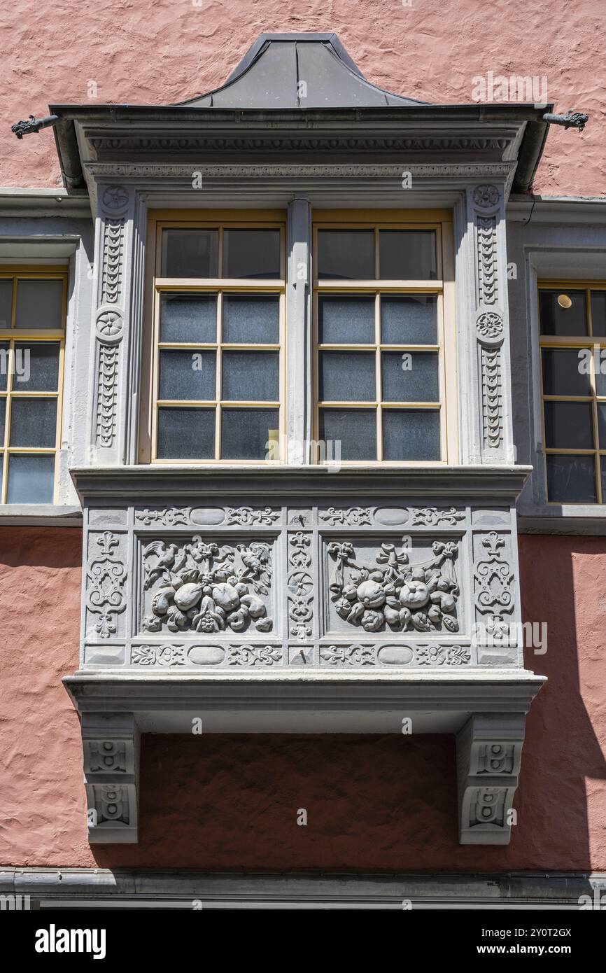 Artfully decorated bay window, stonemasonry work on a historic town ...