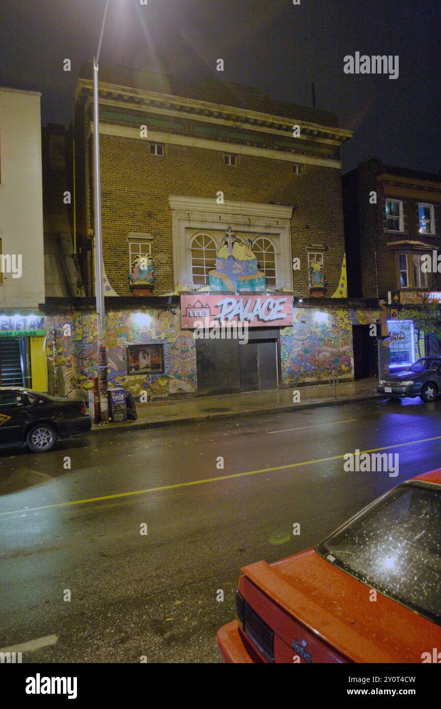 A nighttime street scene featuring a colourful, graffiti-covered ...