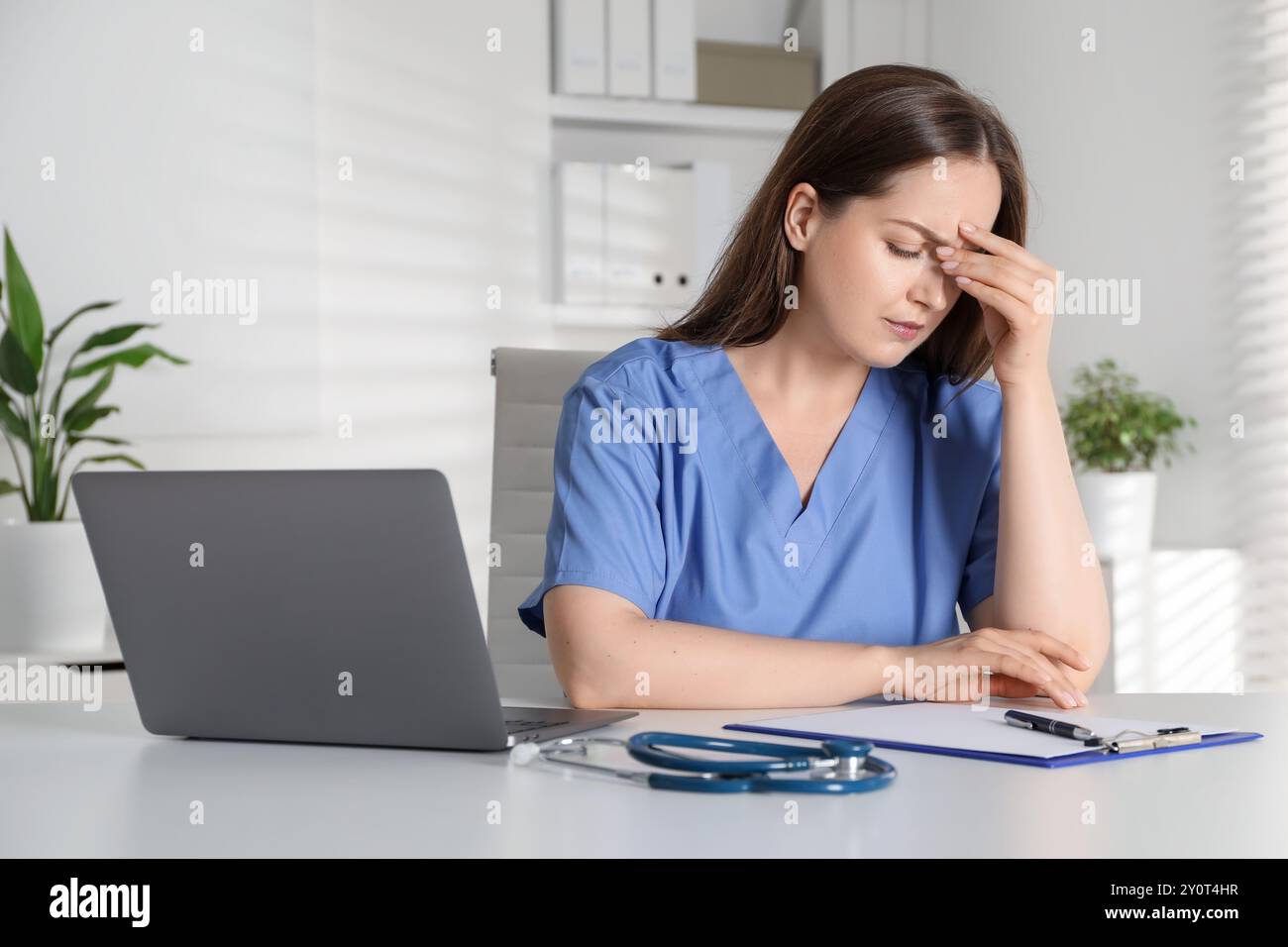Tired young nurse at workplace in hospital Stock Photo - Alamy