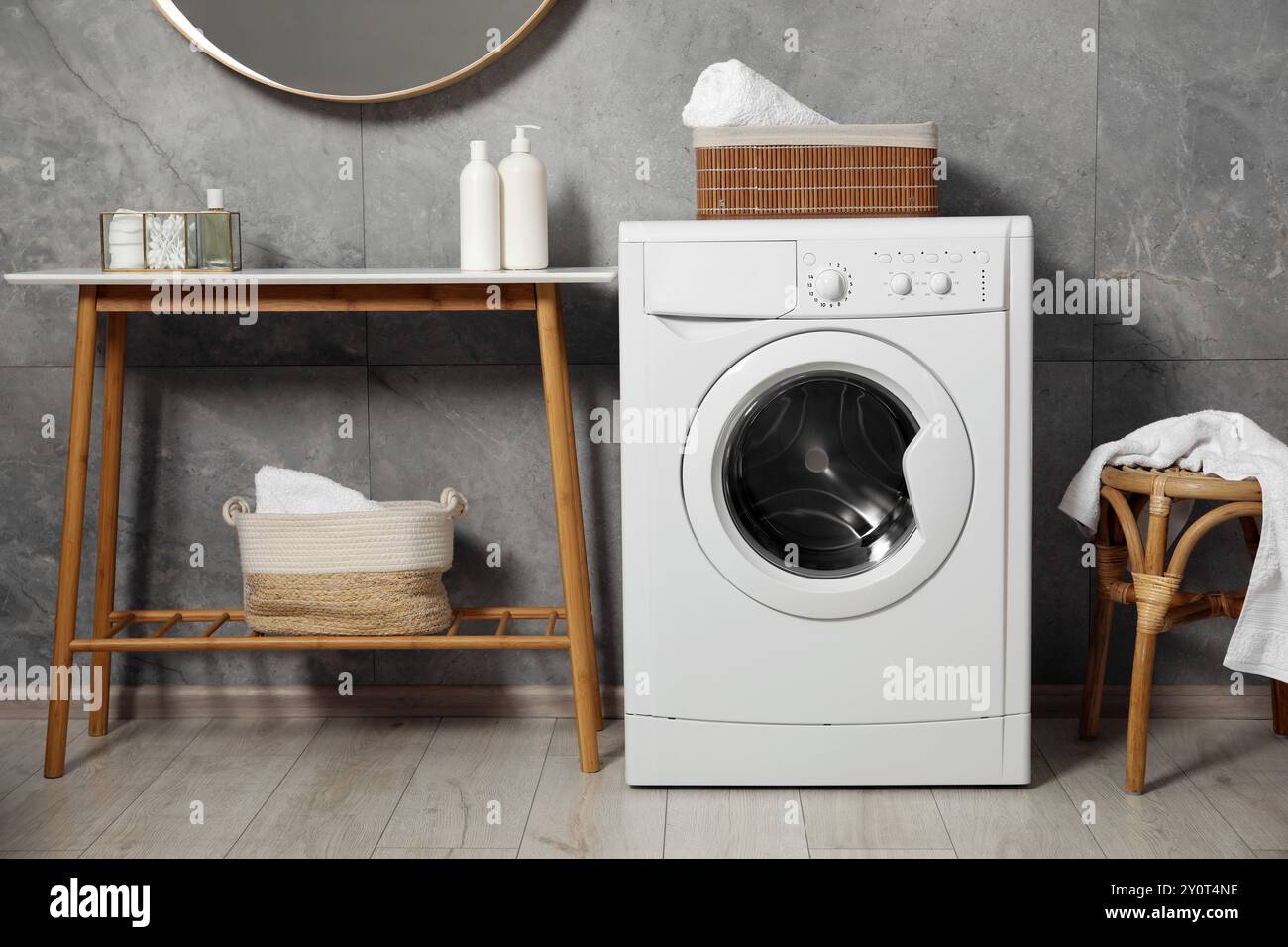 Washing machine, storage bench and chair indoors Stock Photo - Alamy