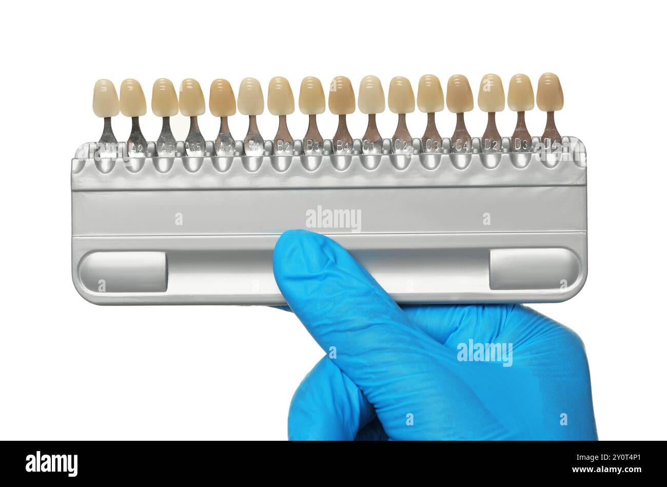 Doctor with teeth color chart on white background, closeup. Dental ...