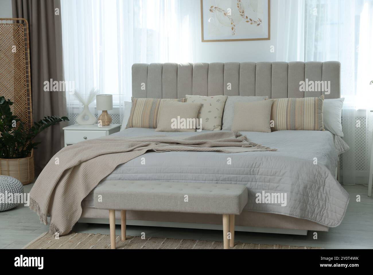 Big comfortable bed in room. Interior design Stock Photo - Alamy