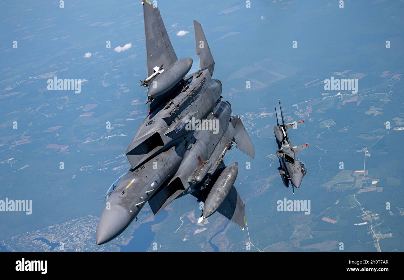 Two F-15 Strike Eagles, assigned to the 4th Fighter Wing, fly in ...