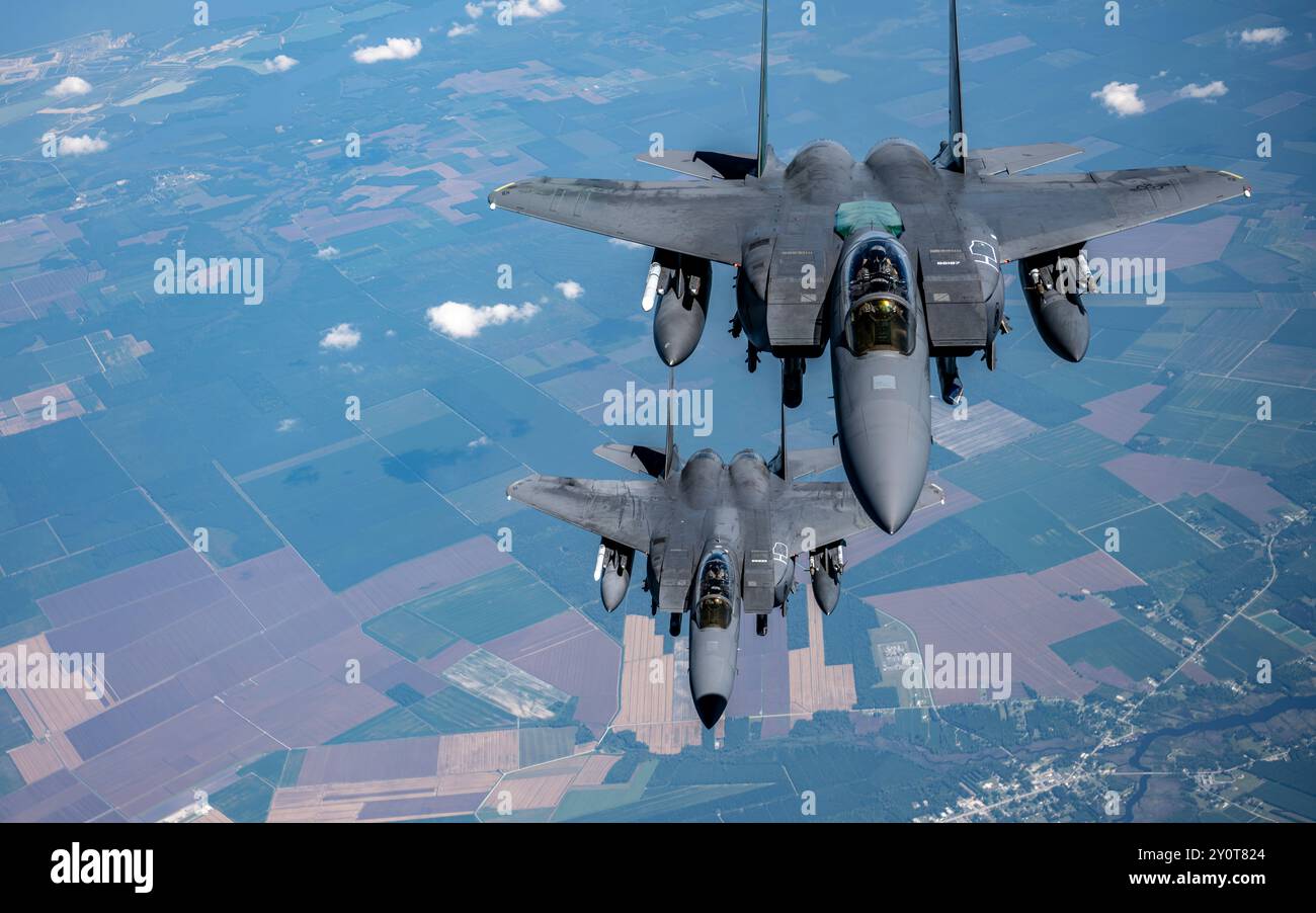 Two F-15 Strike Eagles, assigned to the 4th Fighter Wing, fly in ...