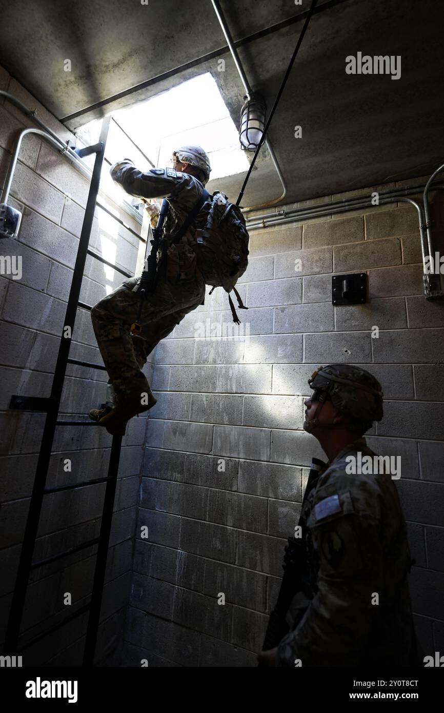 Army Reserve Best Squad competitor ascends a ladder during ...