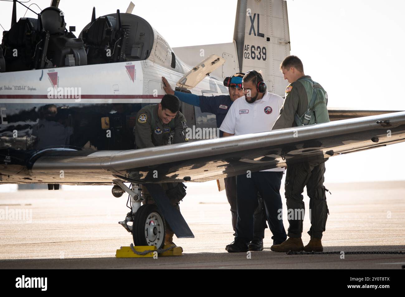 U.S. Air Force pilots and maintainers stand next to a T-6A Texan II ...