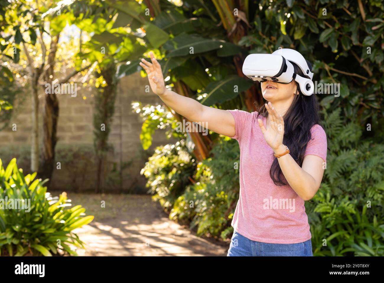 Using VR headset, Asian woman interacting with virtual environment outside Stock Photo - Alamy