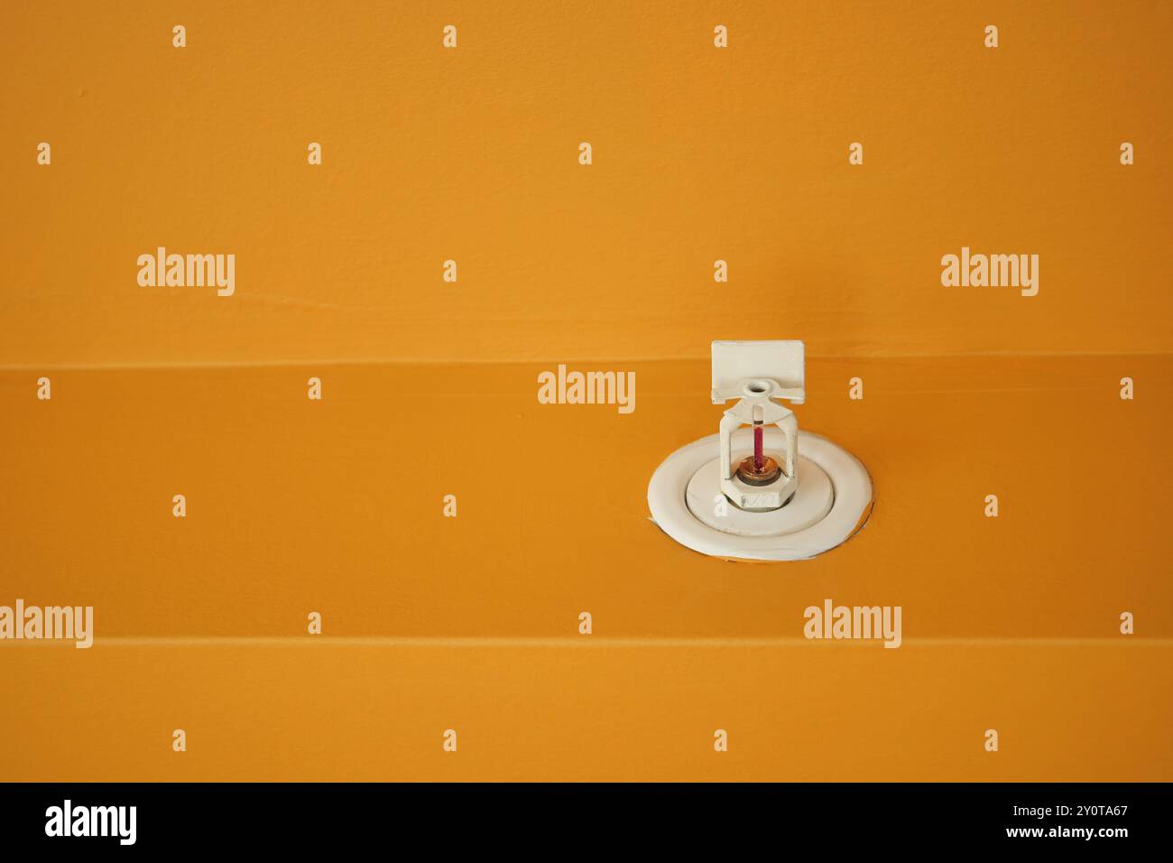 A Contemporary Fire Sprinkler Set Against a Bold and Vibrant Orange ...