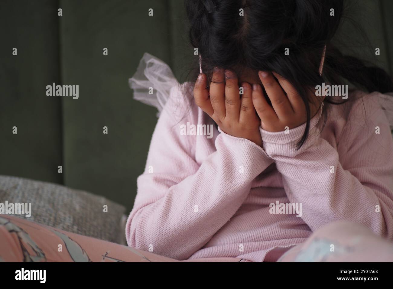 A Child Covering Their Face with Hands in a Deeply Emotional Moment of ...