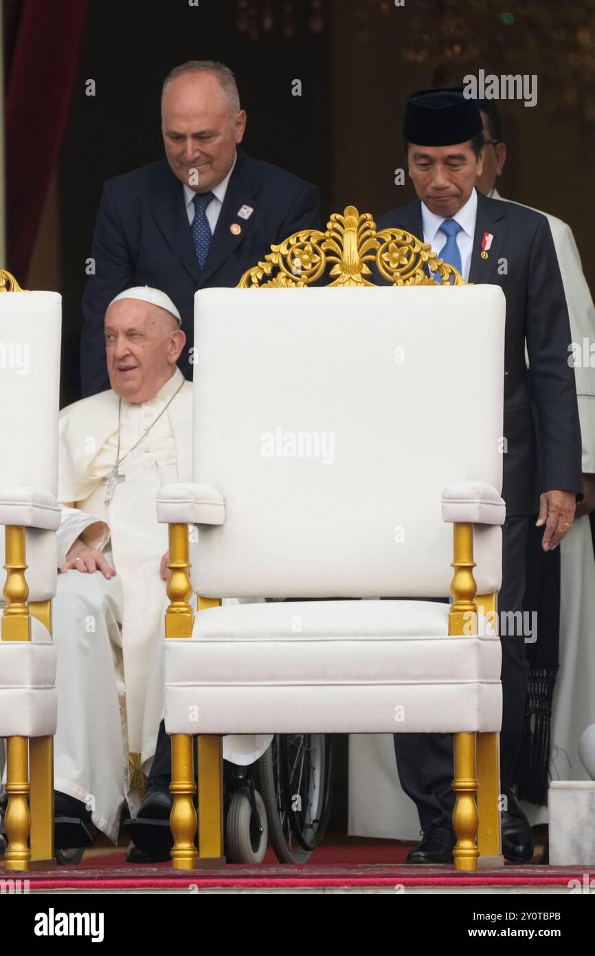 Indonesian President Joko Widodo, right, receives Pope Francis, helped ...