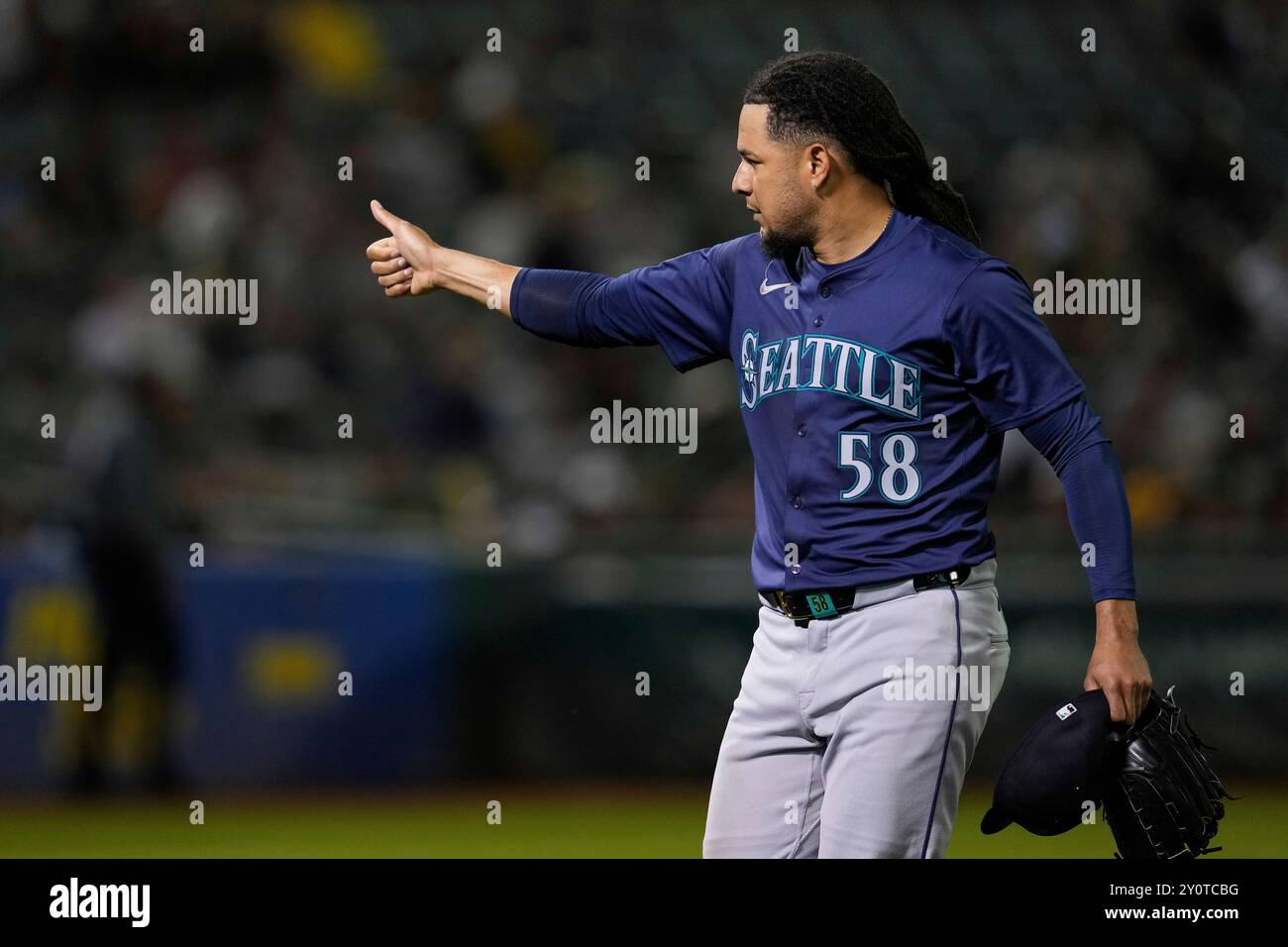 Seattle Mariners pitcher Luis Castillo gives a thumbs-up as he walks to ...