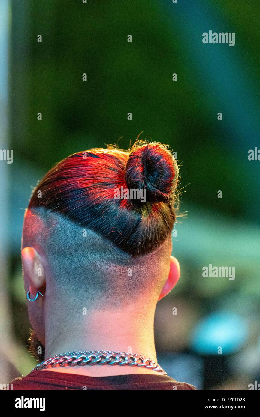 Stage Spotlight: Close-Up of Young Man's Single Bun Hairstyle – Partial ...