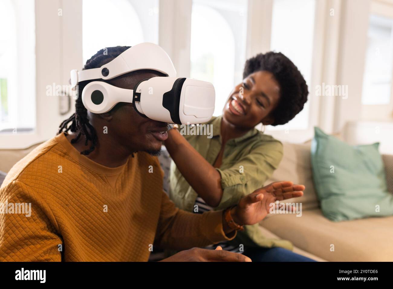 Using vr headset, african american man enjoying virtual reality with ...