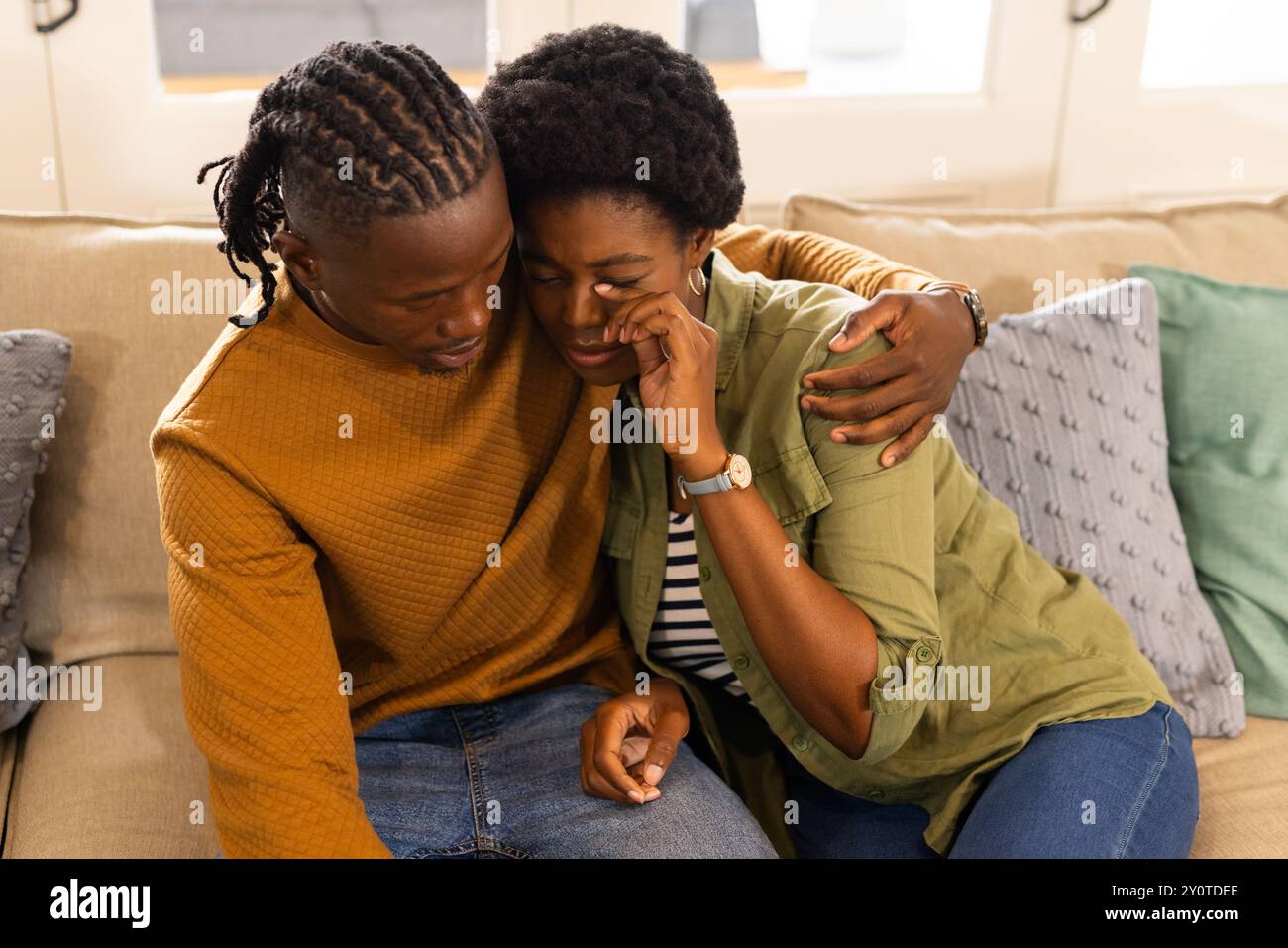 Comforting partner, african american man hugging and consoling woman on ...