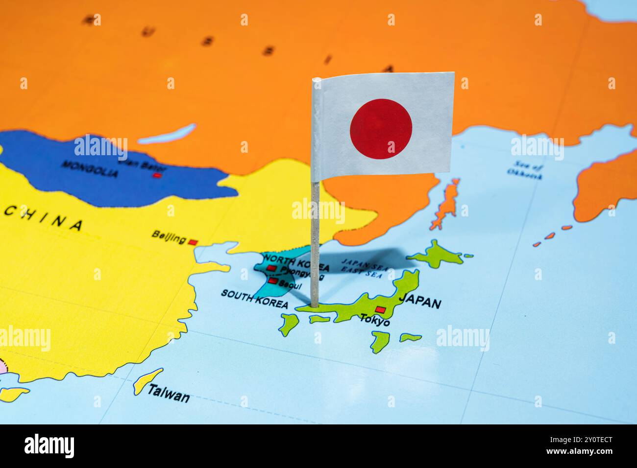 A map of Japan with a Japanese flag on it. The flag is red and white ...