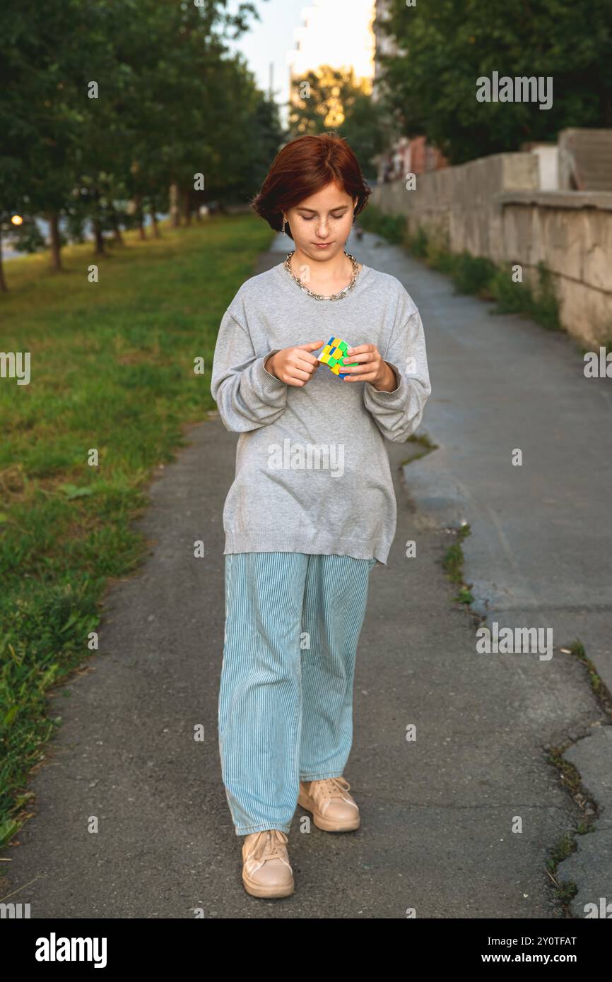 Ekaterinburg, Russia, February 14 2024: Cute girl outdoors solving a ...