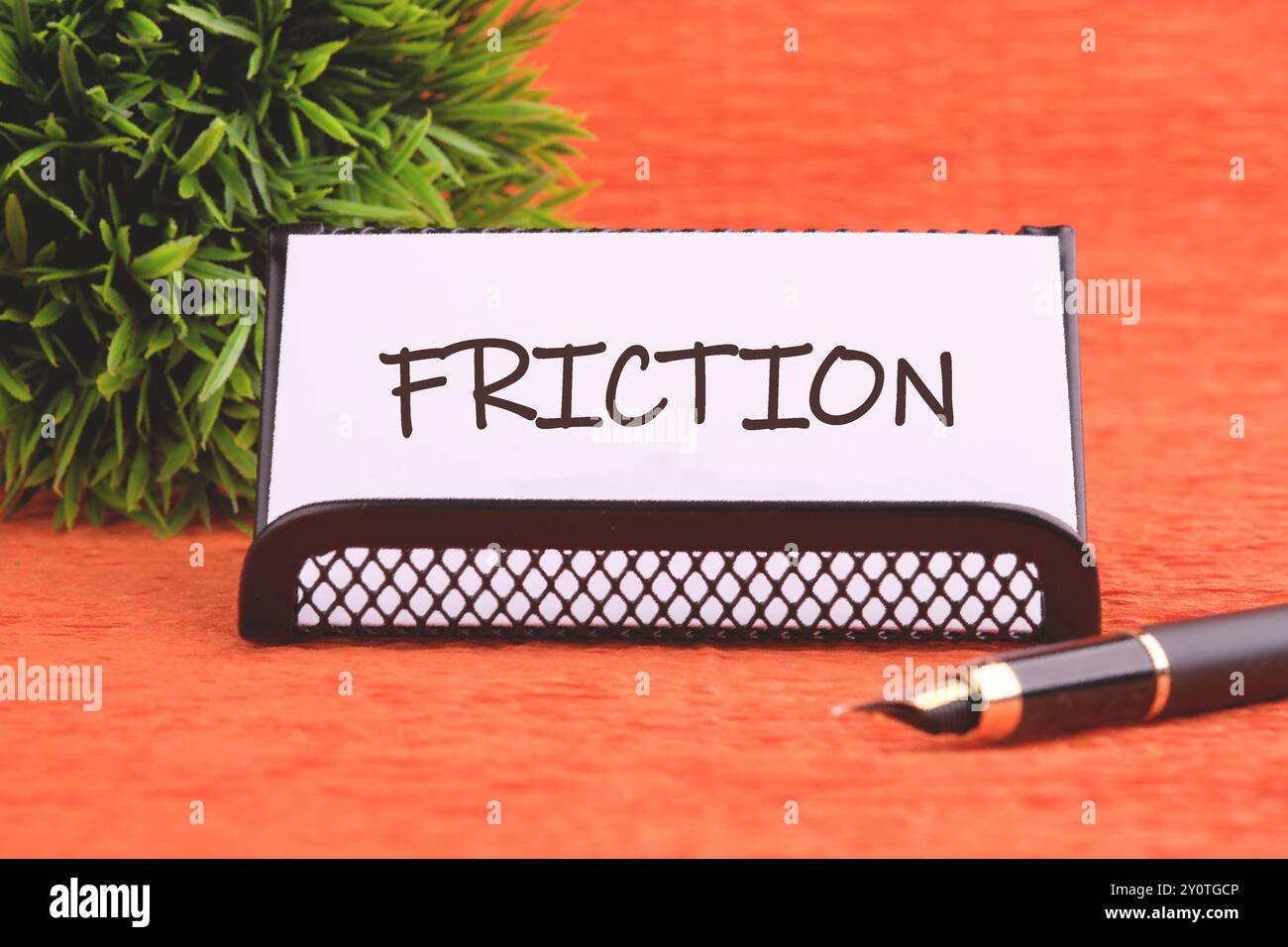 Friction concept. Friction word on a white business card in a business ...