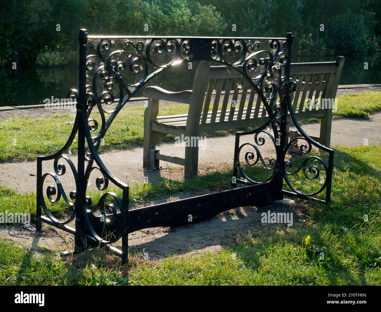 Sun-lit bench and a strange wrought iron framework by the Thames at ...