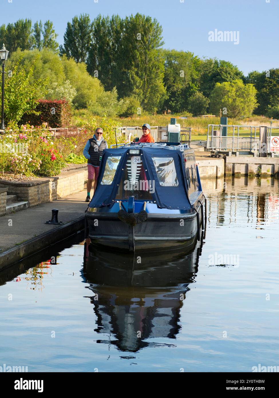 Houseboat passing through Sandford Lock on the Tmames, on a fine late ...